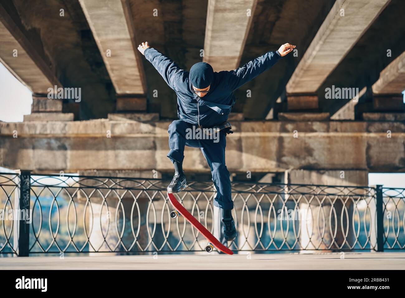 Skateboarder doing a trick on the street urban background. Extreme ...