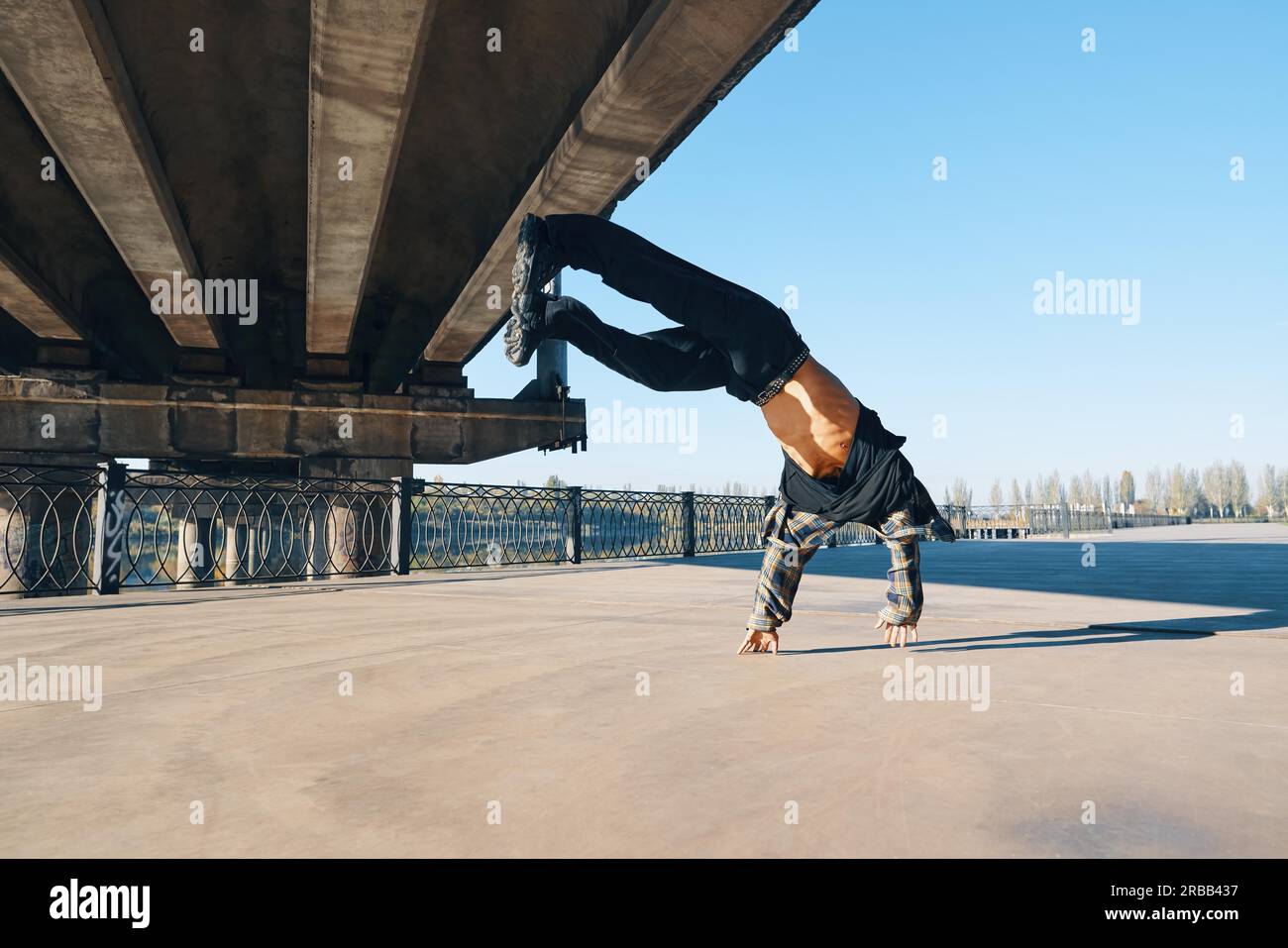 Young man break dancer doing somersault acrobatic stunts dancing on ...