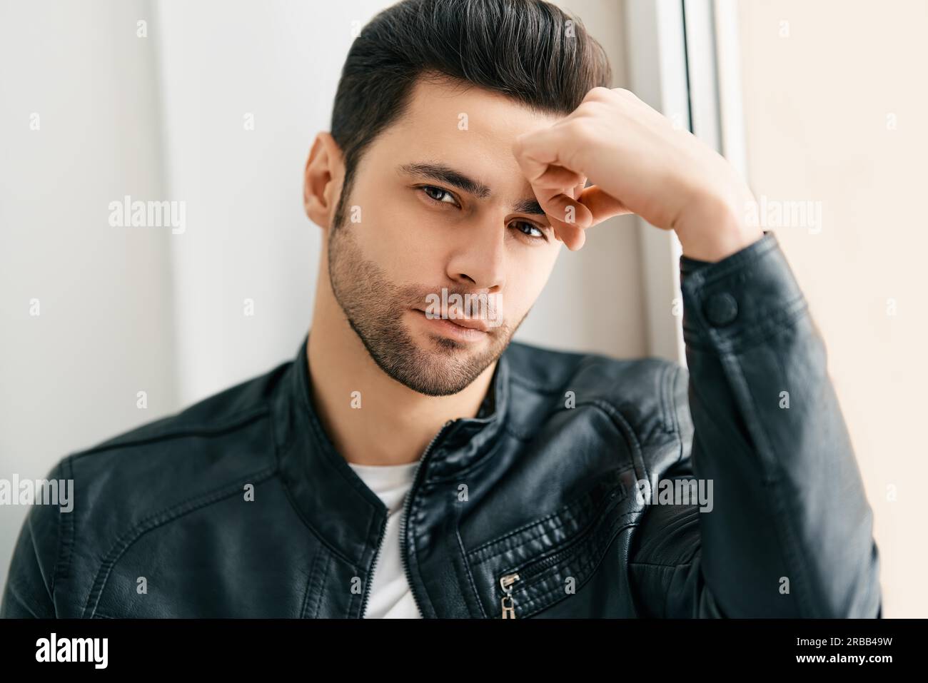 Closeup portrait of handsome thoughtful man posing on white studio ...
