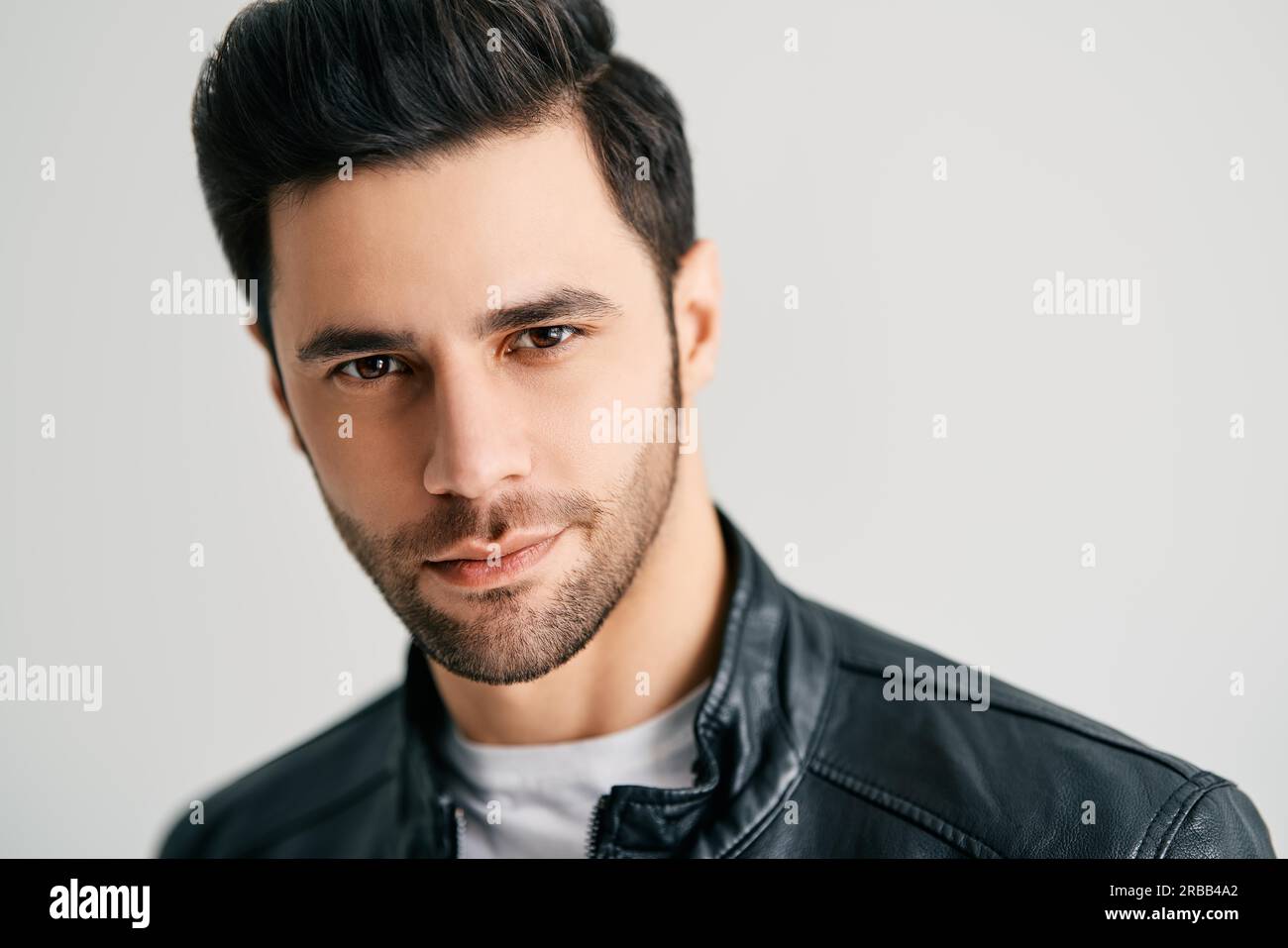 Closeup portrait of handsome trendy man posing on white studio ...