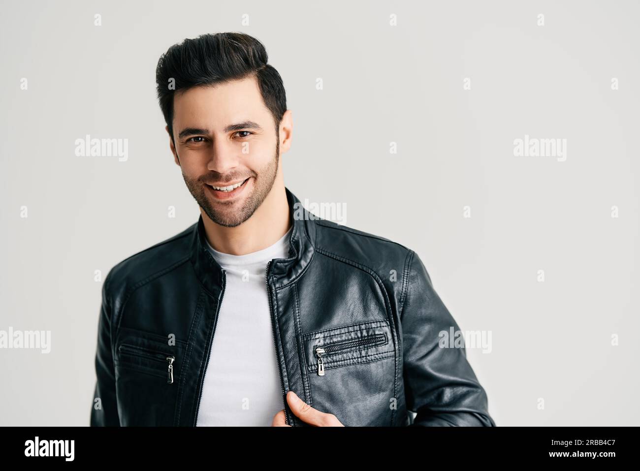 Closeup portrait of smiling handsome trendy man posing on white studio ...