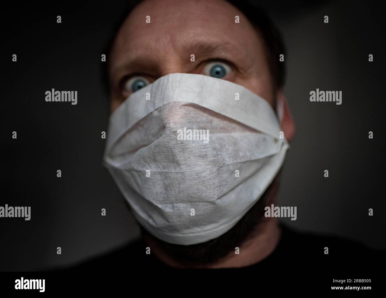 Man with face mask, fear of infection Stock Photo - Alamy