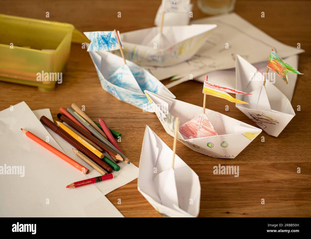 Paper ships made and painted by children Stock Photo - Alamy