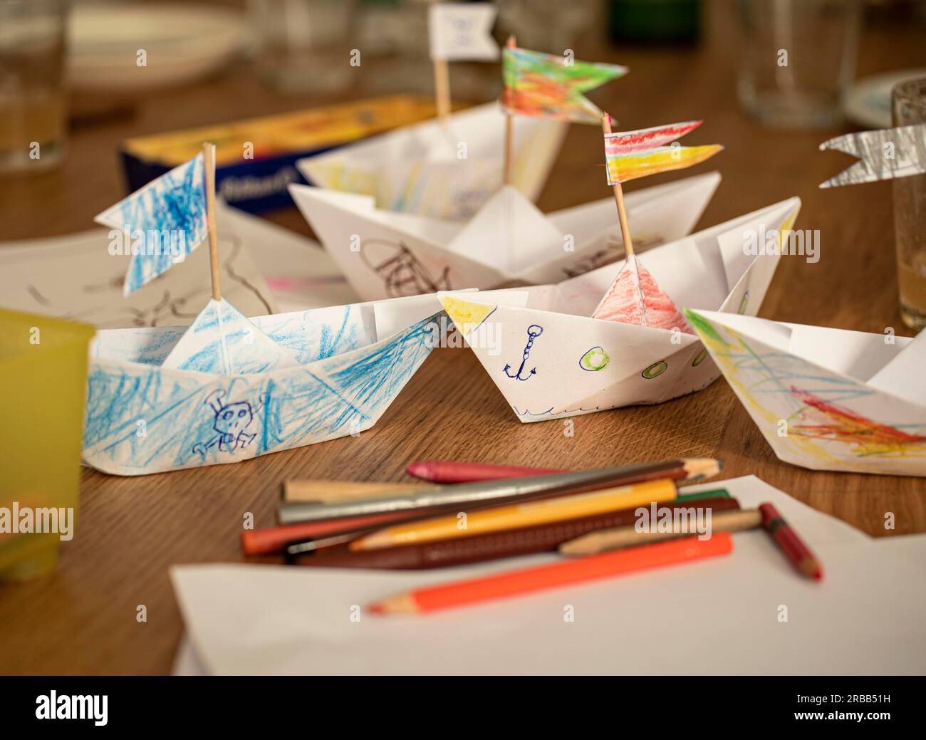 Paper ships made and painted by children Stock Photo - Alamy