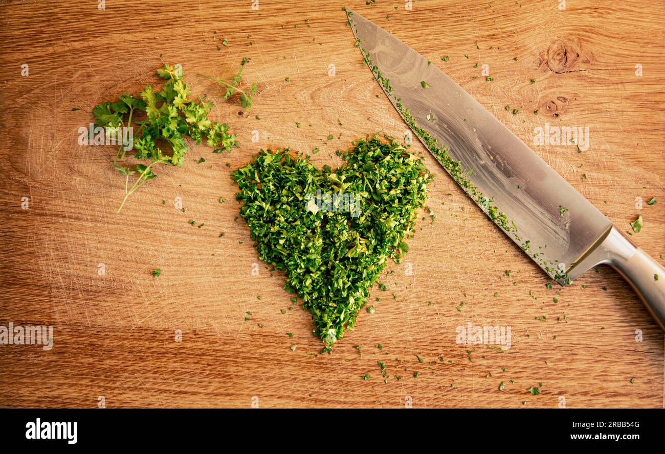 Cutting Board with Parsley Cut in Heart Shape Stock Photo - Alamy
