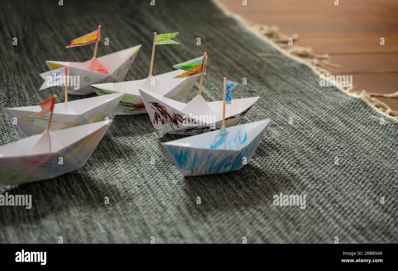 Paper ships made and painted by children Stock Photo - Alamy