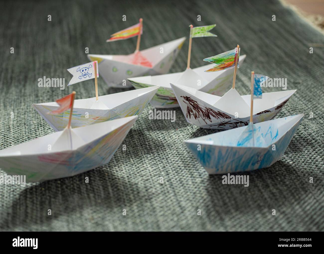 Paper ships made and painted by children Stock Photo - Alamy