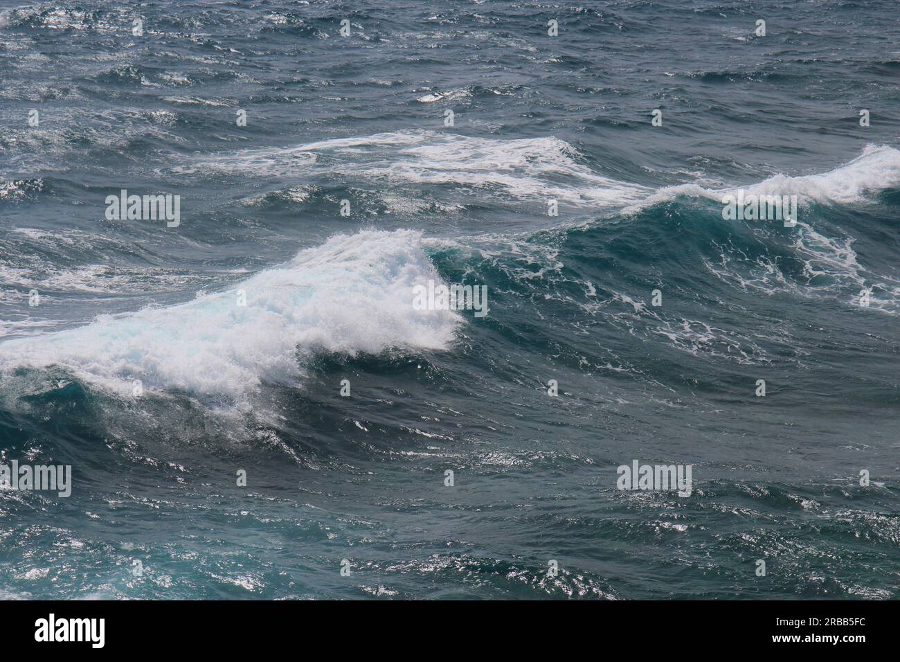 Small waves, with white caps, in varied shades of blue in the Pacific ...