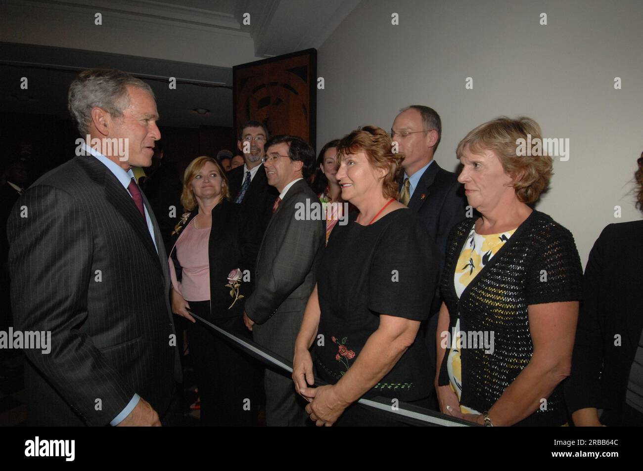Department staff greeting President George W. Bush, from behind rope ...