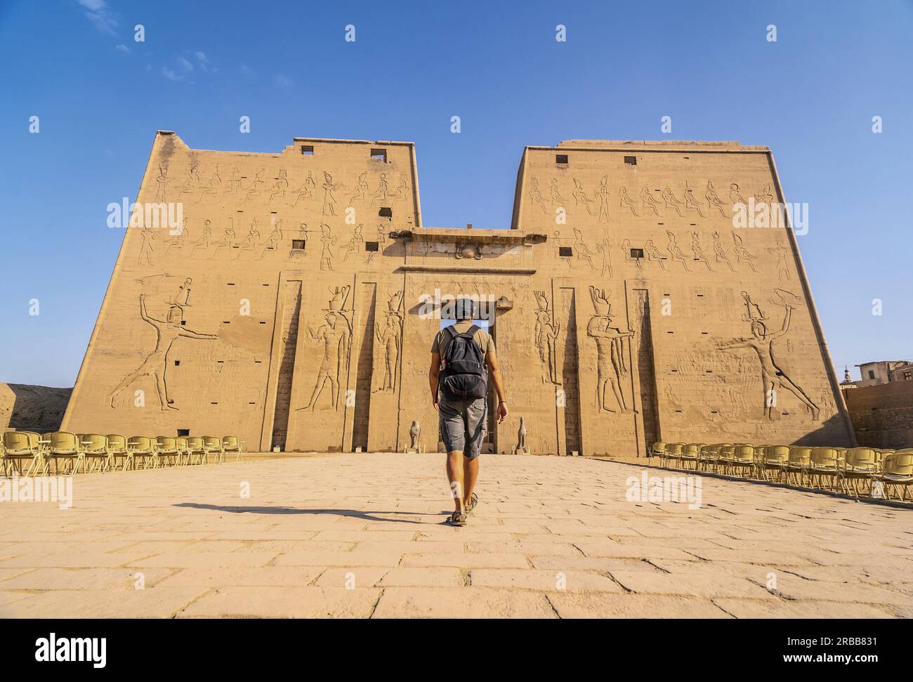 A young tourist entering the Temple of Edfu in the city of Edfu, Egypt ...
