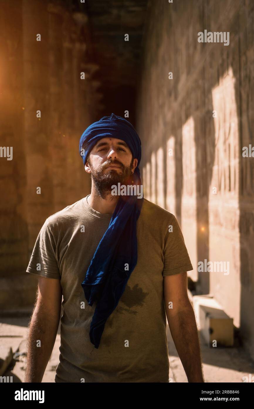 A young tourist in a blue turban visiting the Edfu Temple in the ...