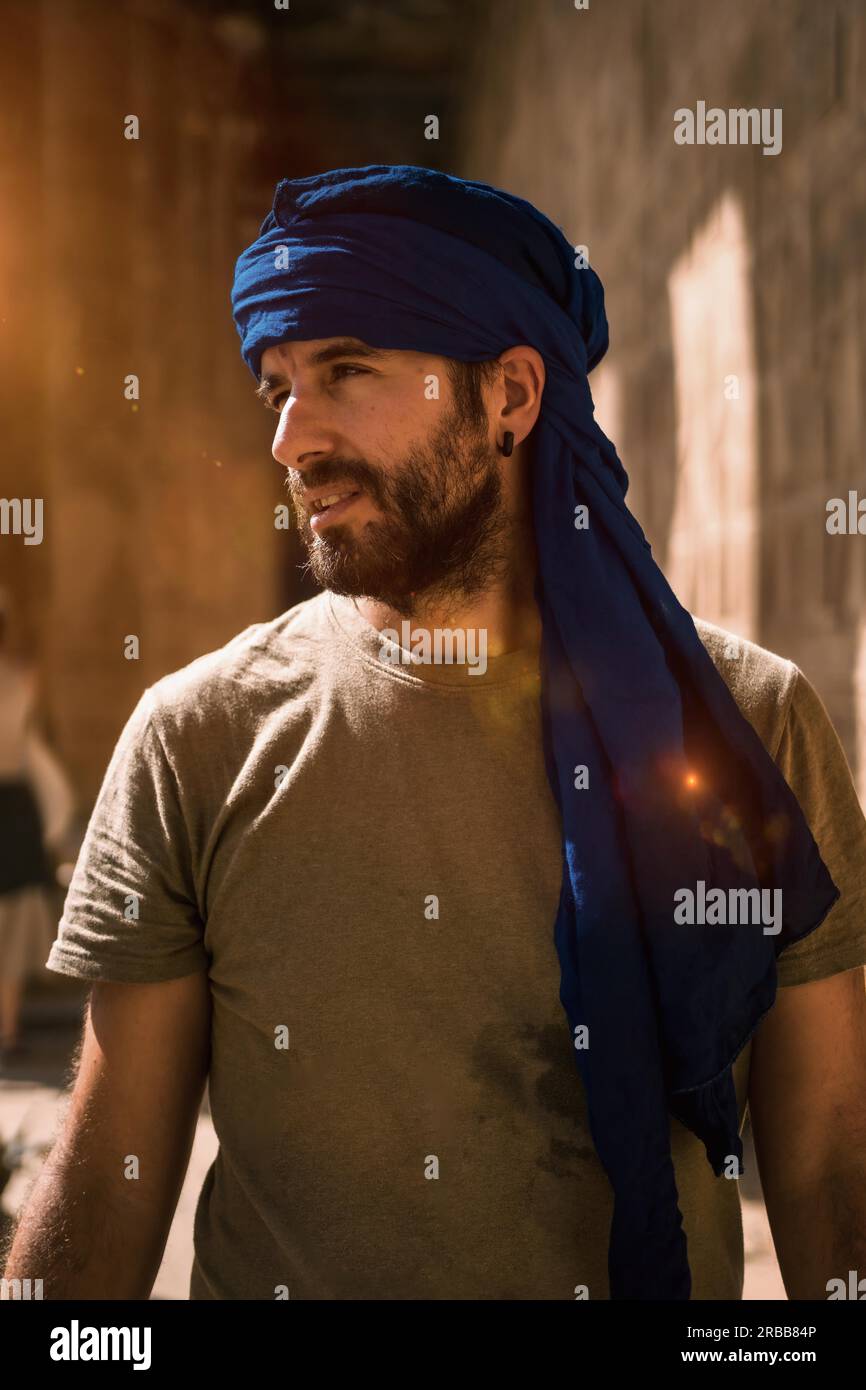 A young tourist in a blue turban visiting the Edfu Temple in the ...