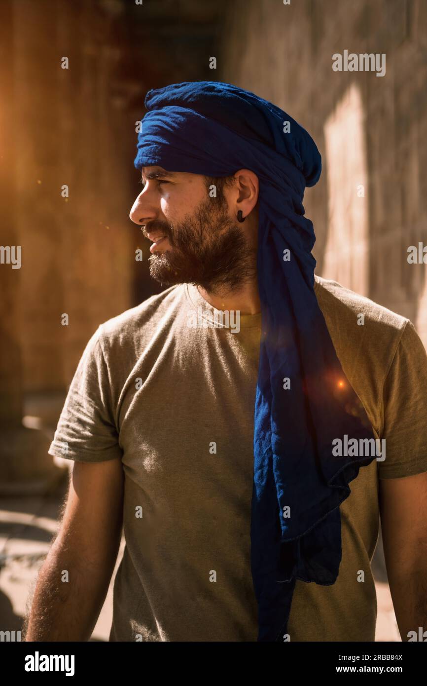 A young tourist in a blue turban visiting the Edfu Temple in the ...