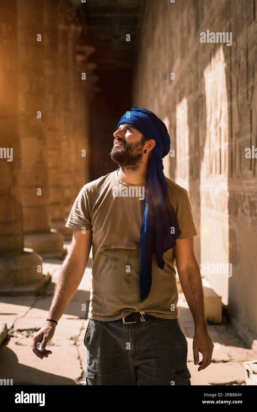 A young tourist in a blue turban visiting the Edfu Temple in the ...