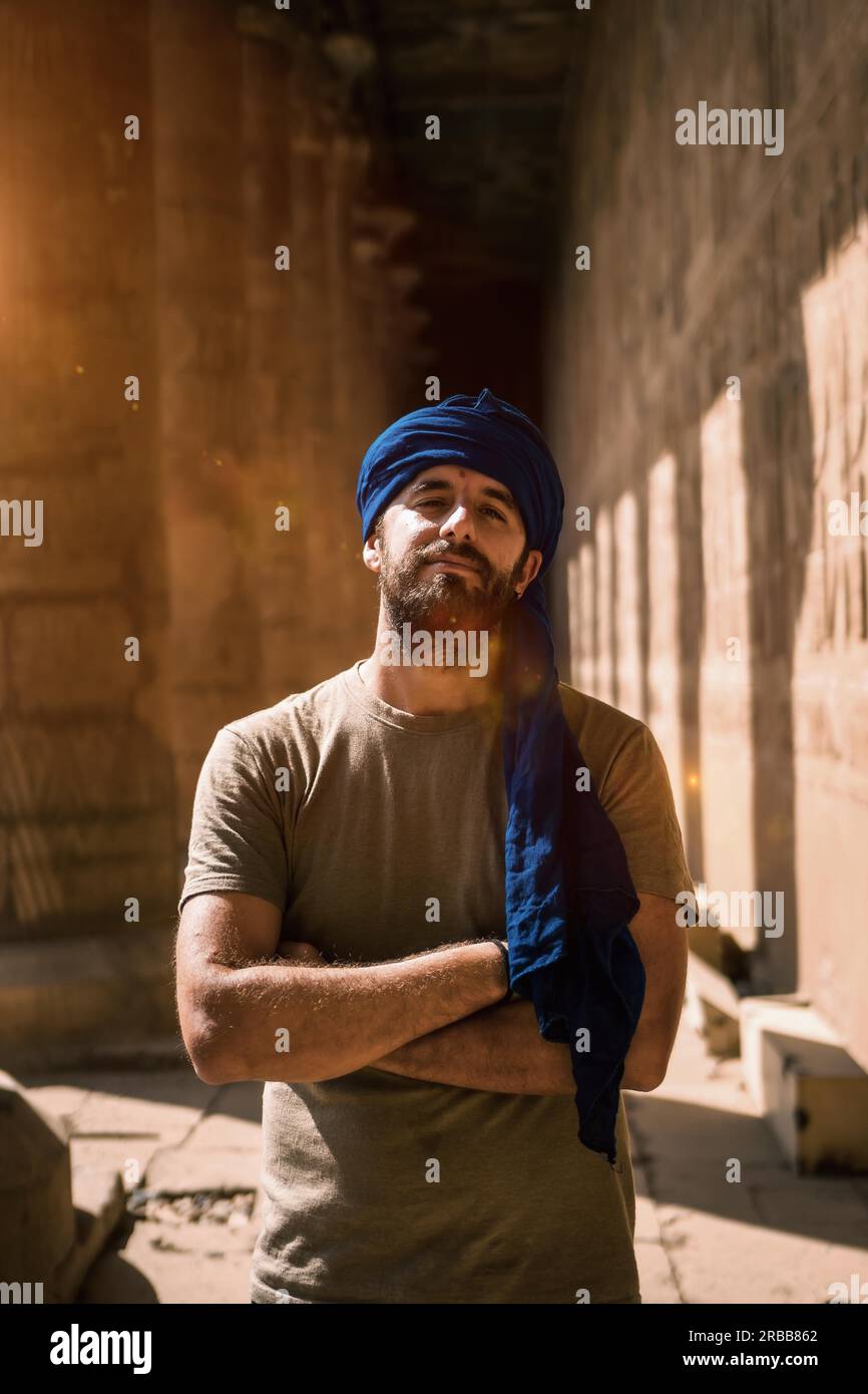 A young tourist in a blue turban visiting the Edfu Temple in the ...