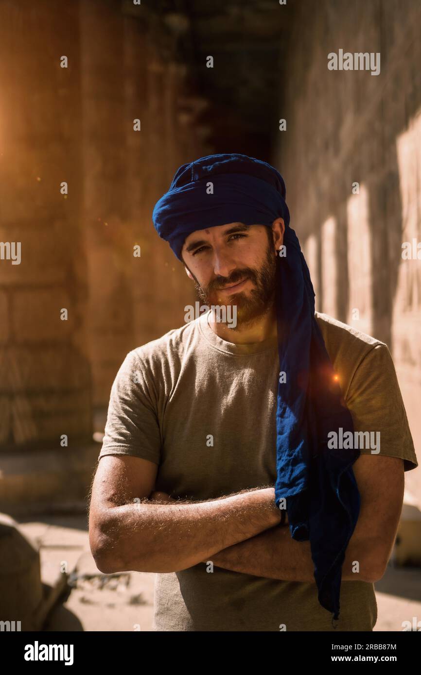 A young tourist in a blue turban visiting the Edfu Temple in the ...