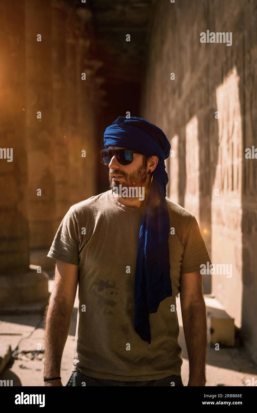 A young tourist in a blue turban visiting the Edfu Temple in the ...