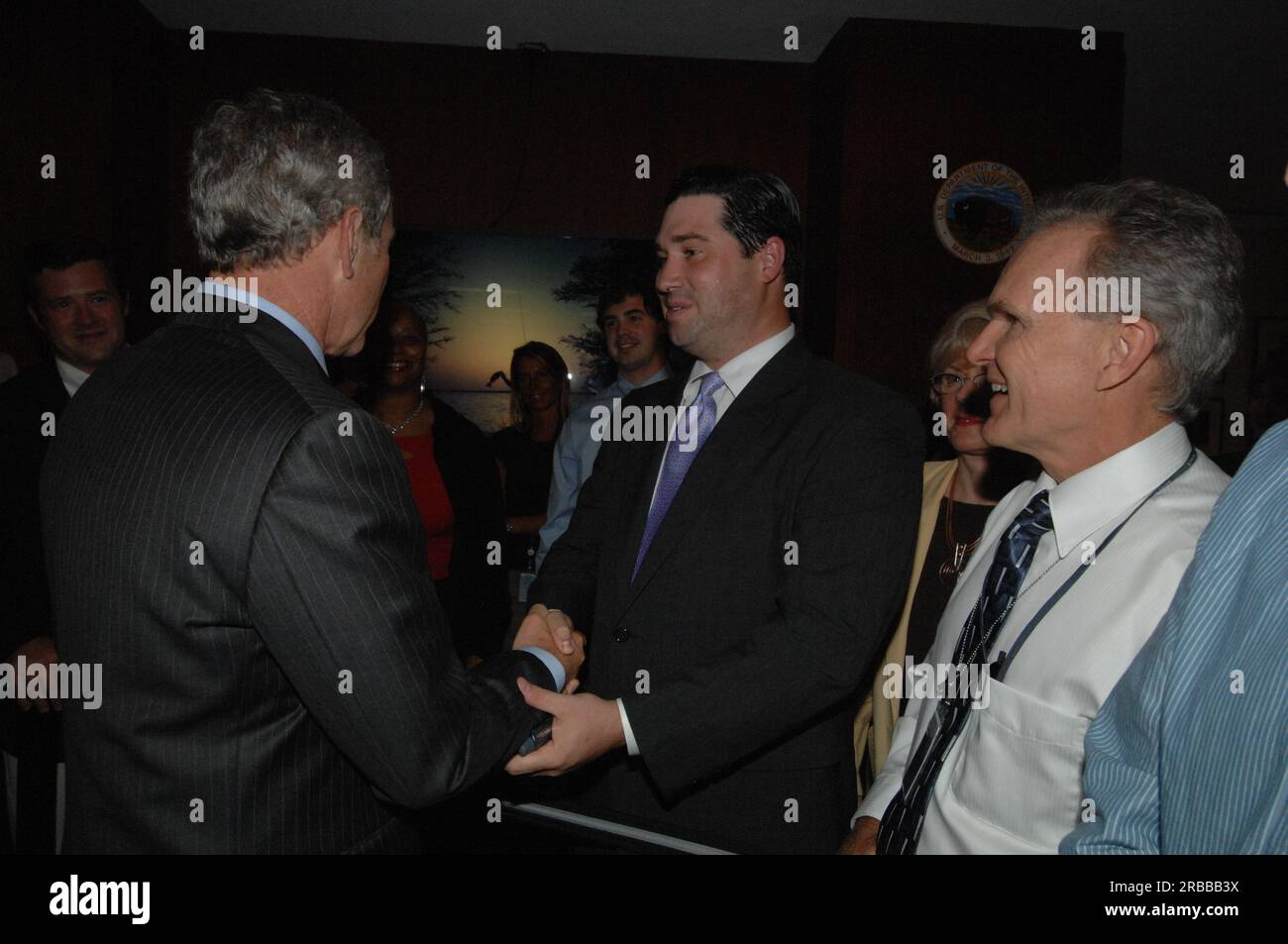 Department staff greeting President George W. Bush, from behind rope ...