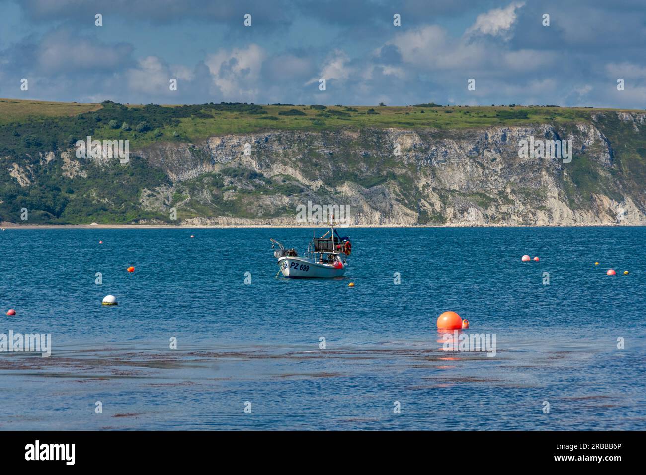 Swanage, UK - June 21st 2023: Fishing boat in the bay in front of ...