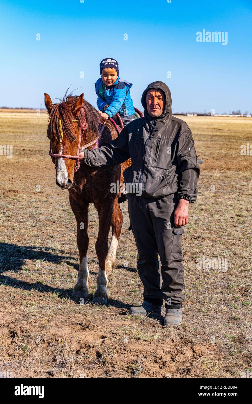 Kokpar player and his son, Kokpar, national horse game, Kazakhstan ...