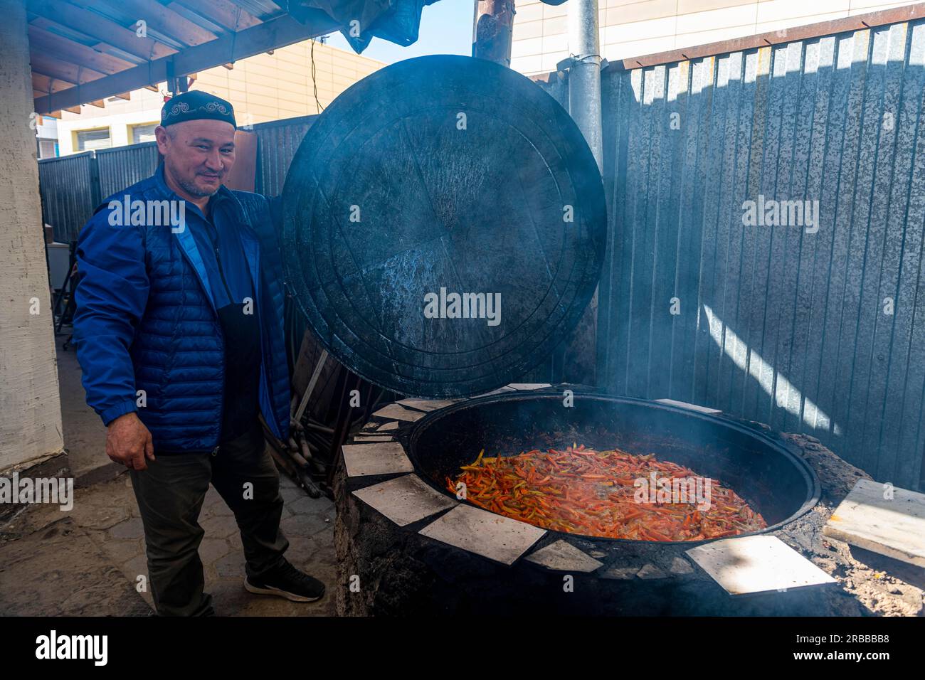 Man preparing a giant feast, Imangali Mosque Mosque, Atyrau, Caspean ...