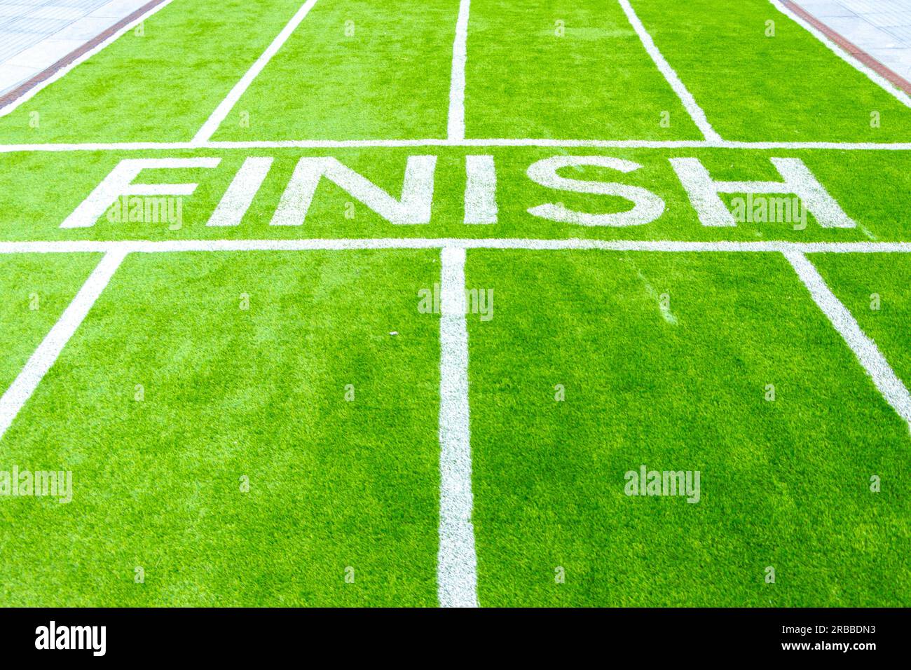 finish line concept white painted lines running race track on grass at ...