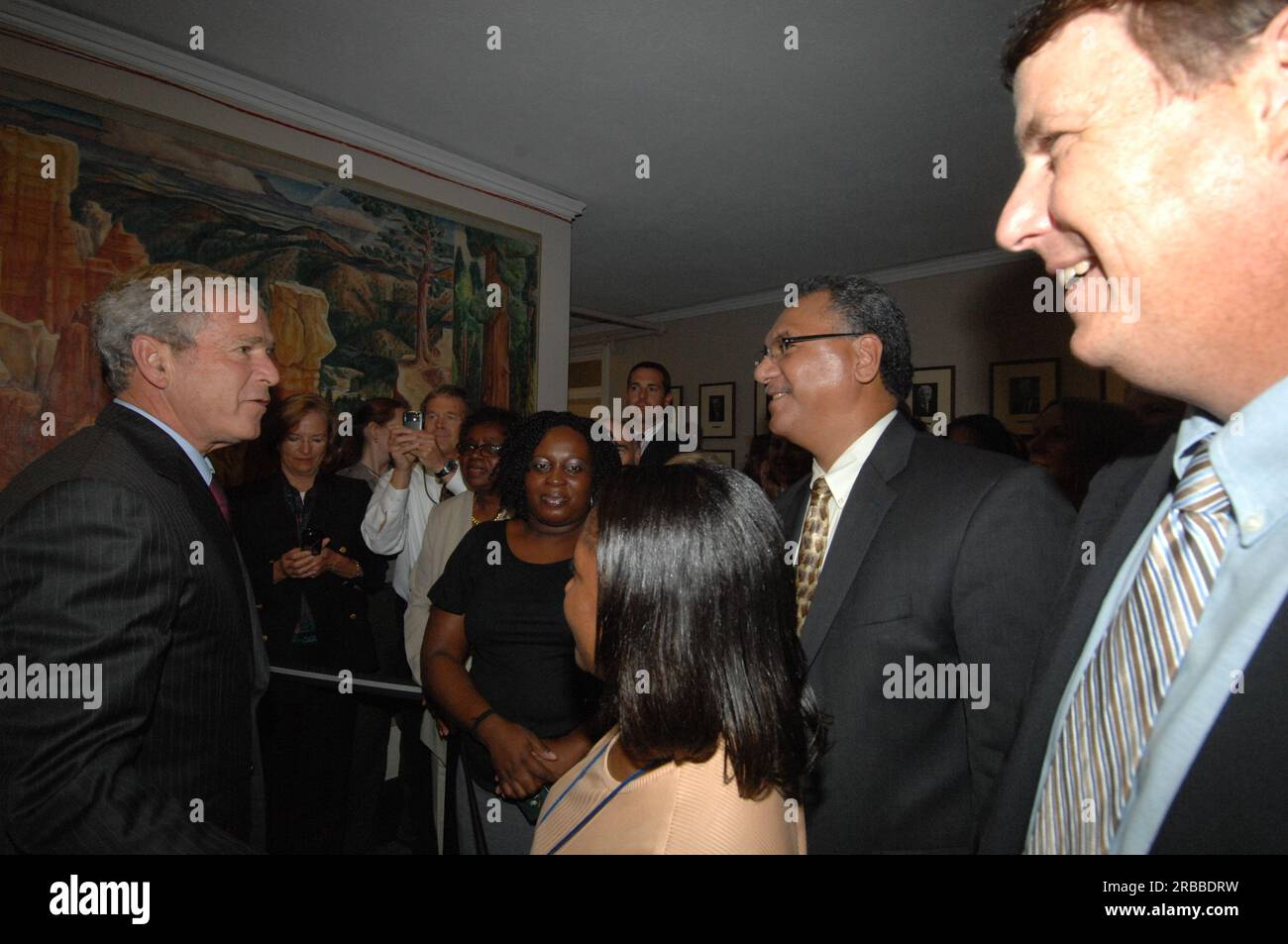 Department staff greeting President George W. Bush, from behind rope ...