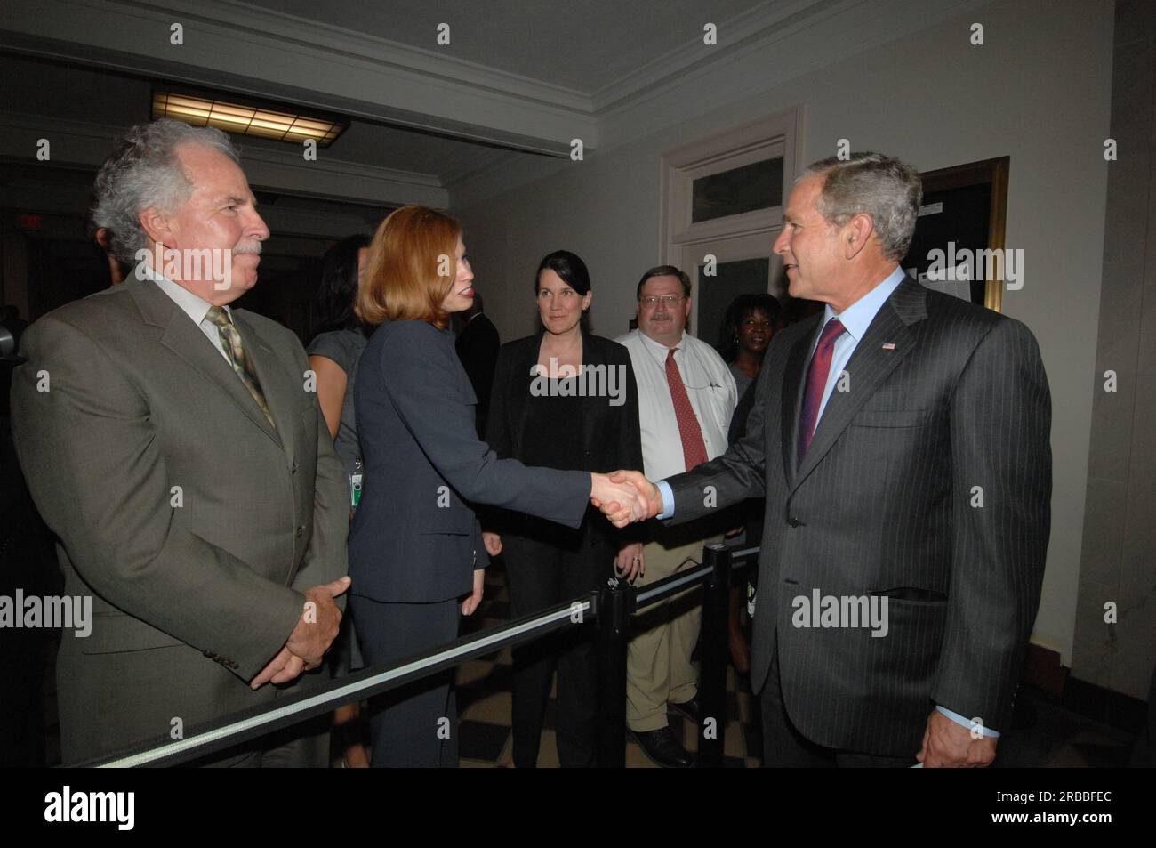 Department staff greeting President George W. Bush, from behind rope ...