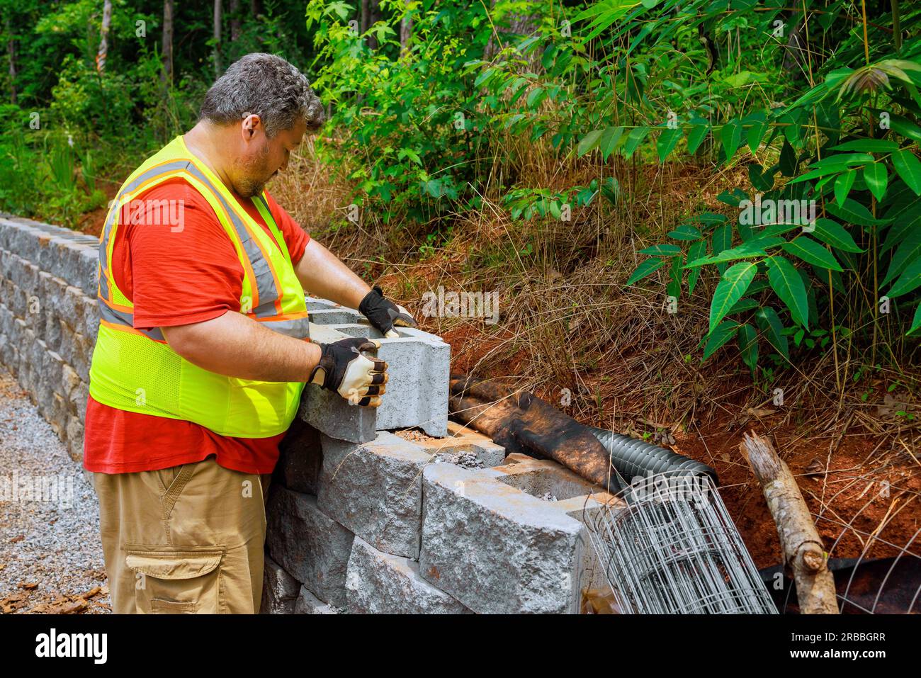 Construction worker on construction site was mounting concrete block to ...