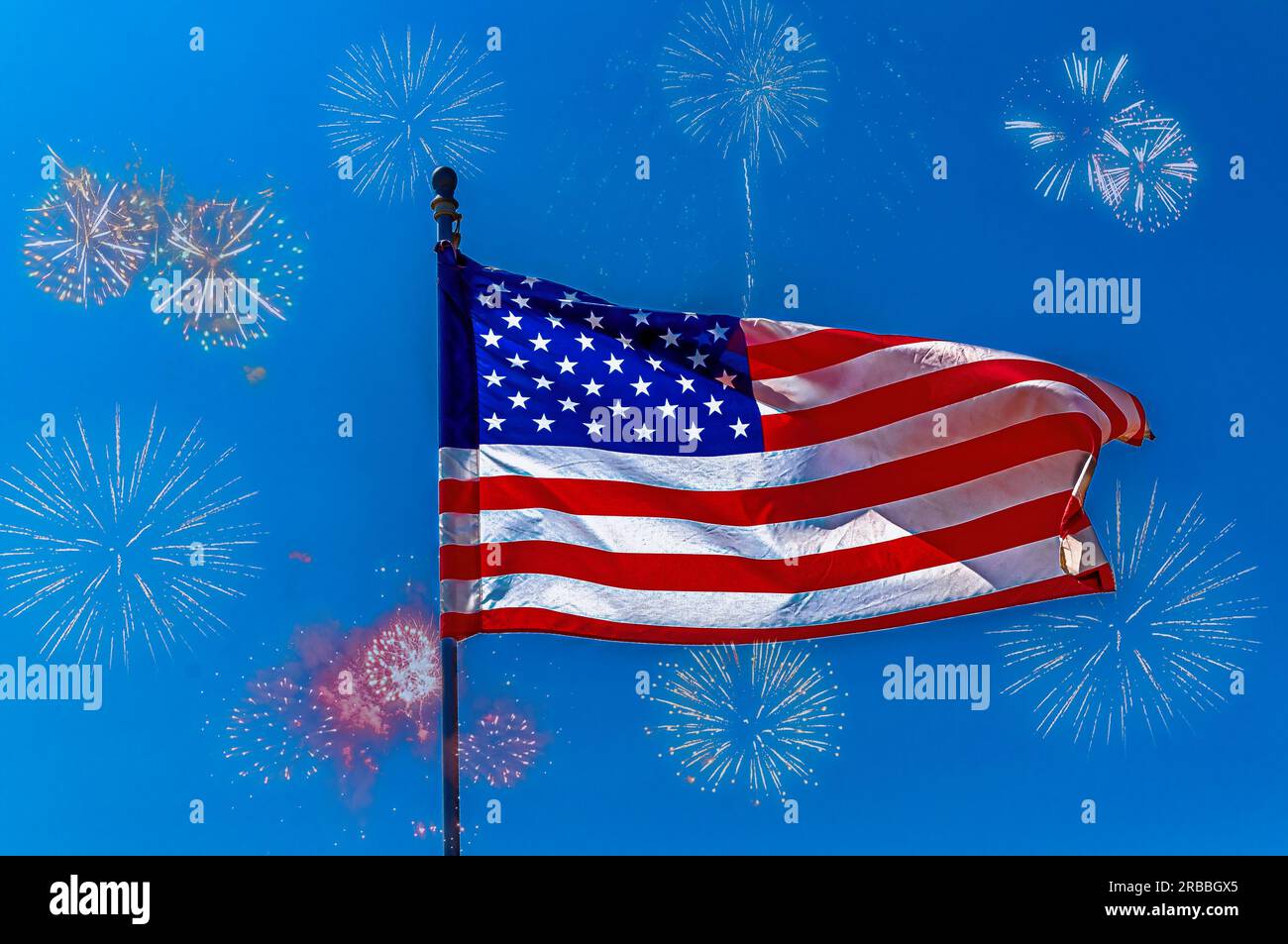 The American Flag Unfurling at Dusk with Fireworks Stock Photo - Alamy