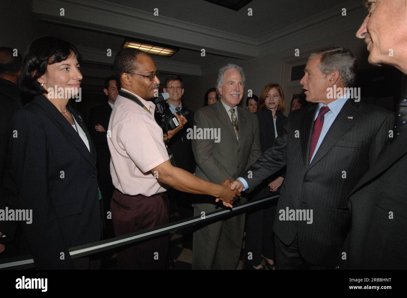 Department staff greeting President George W. Bush, from behind rope ...