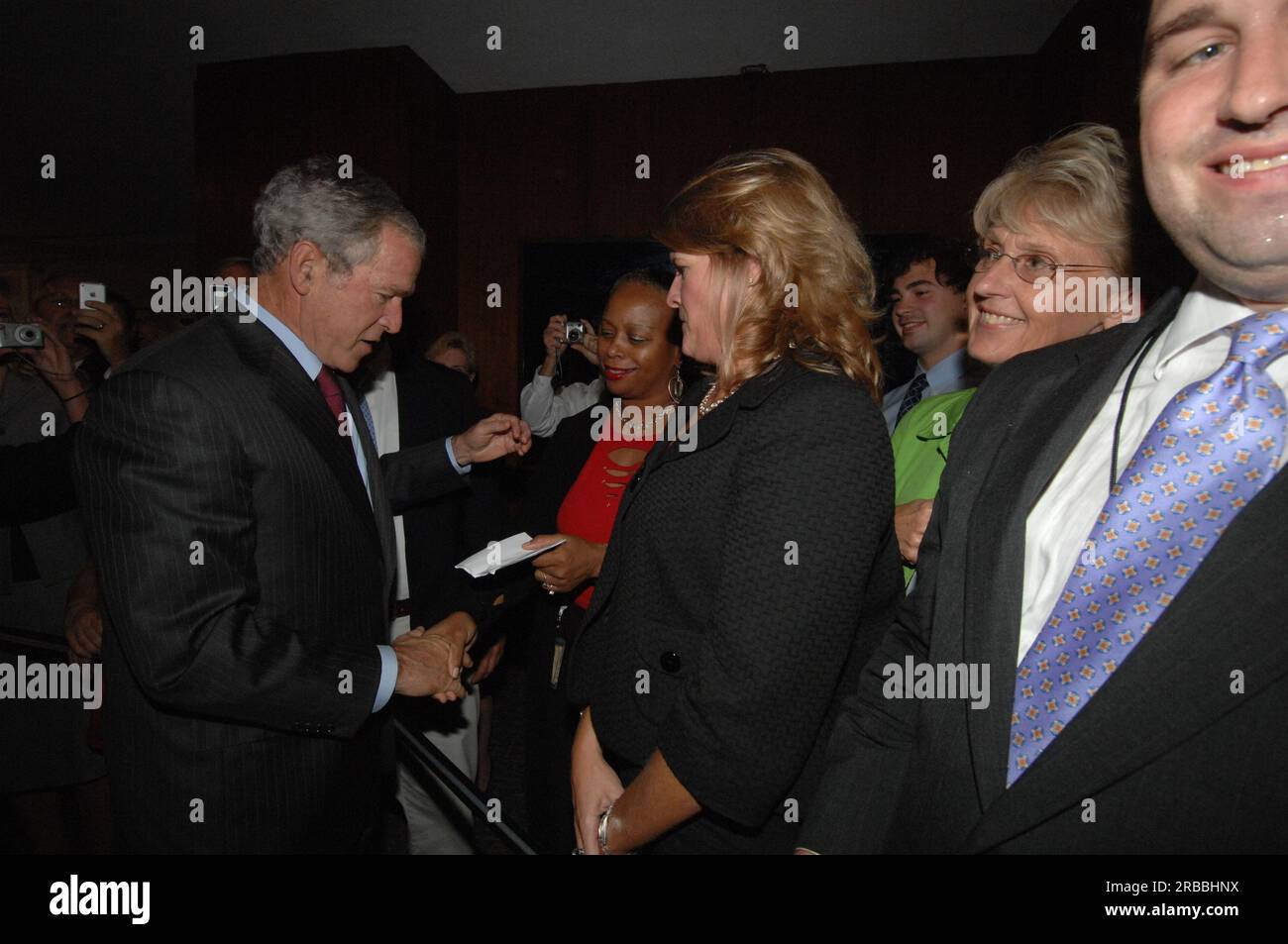 Department staff greeting President George W. Bush, from behind rope ...