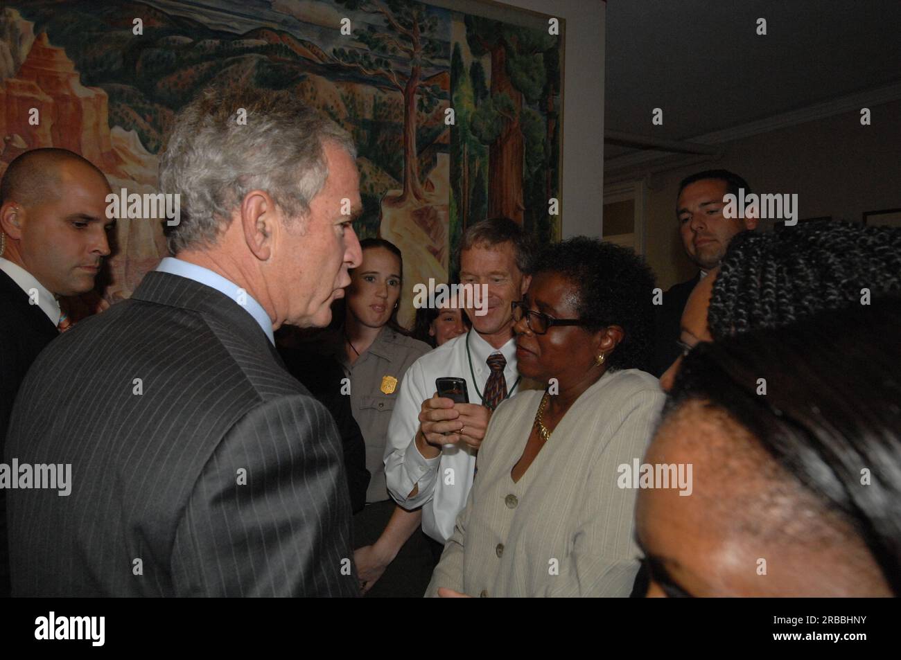 Department staff greeting President George W. Bush, from behind rope ...