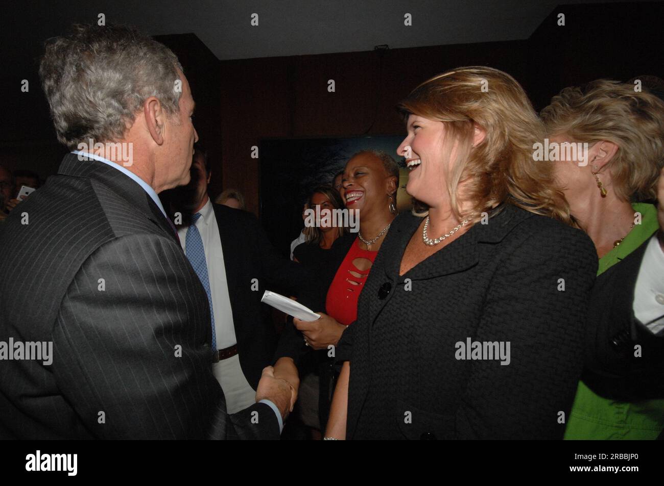 Department staff greeting President George W. Bush, from behind rope ...