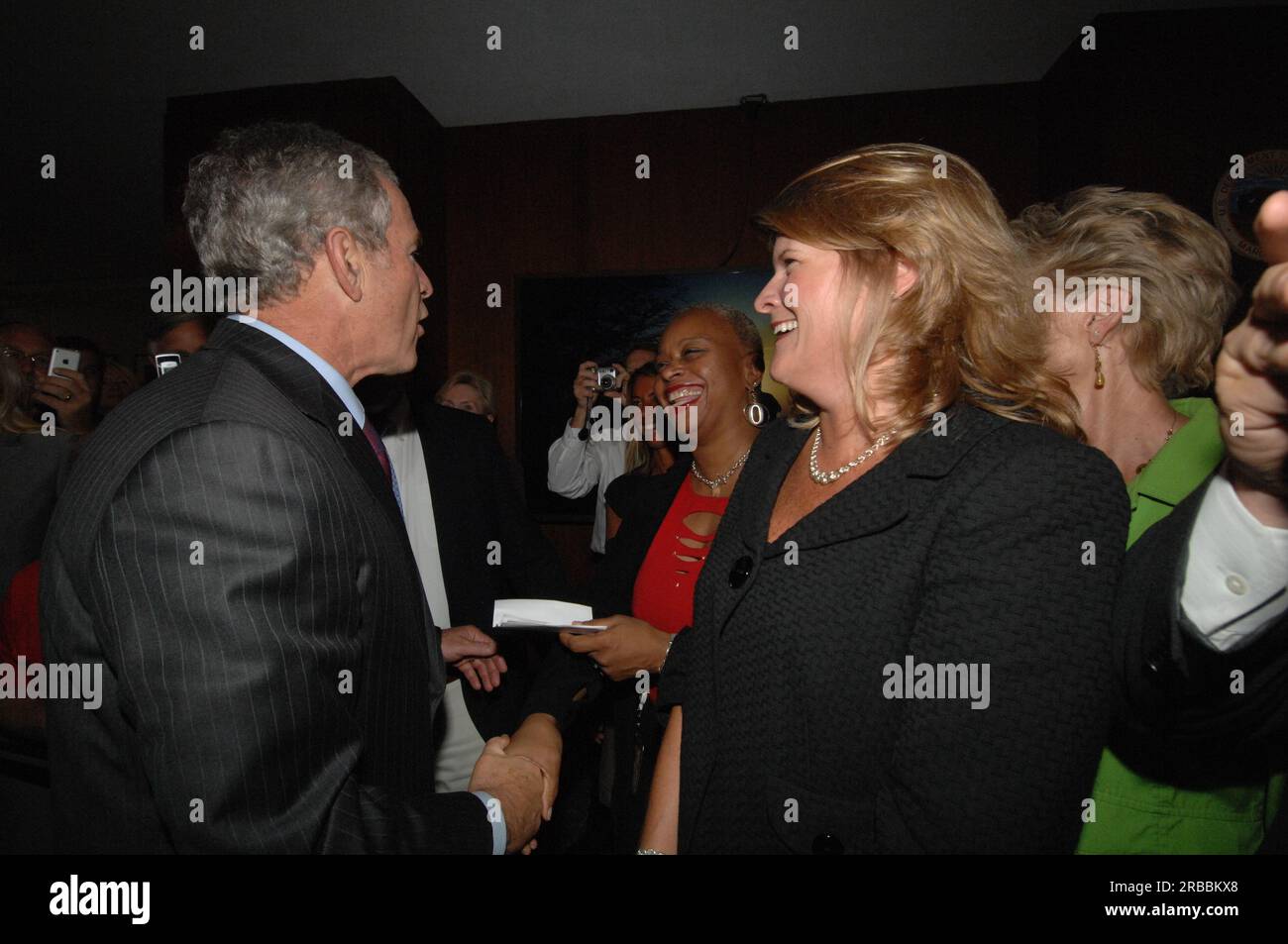 Department staff greeting President George W. Bush, from behind rope ...