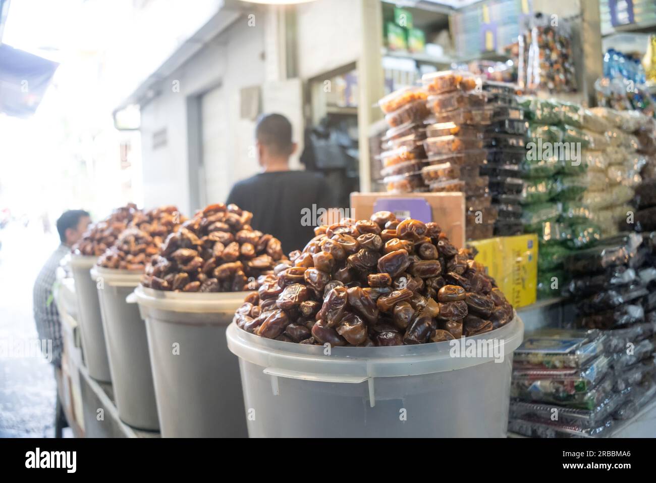 July 8. People in the market selling dates and assorted chickpeas near ...