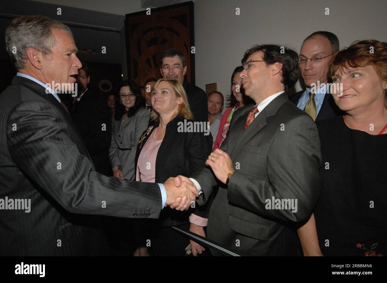 Department staff greeting President George W. Bush, from behind rope ...