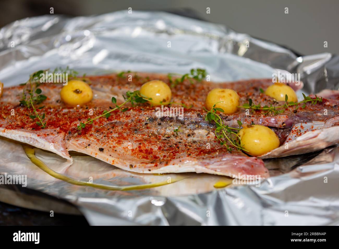 Traditional anchovy fish (Pomatomus saltador) seasoned ready to be ...