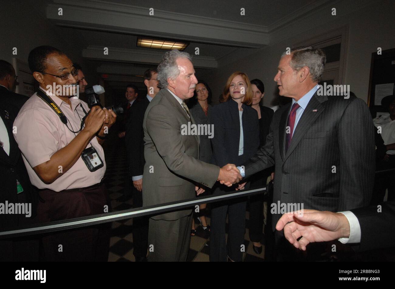 Department staff greeting President George W. Bush, from behind rope ...