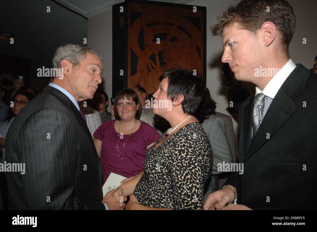 Department staff greeting President George W. Bush, from behind rope ...
