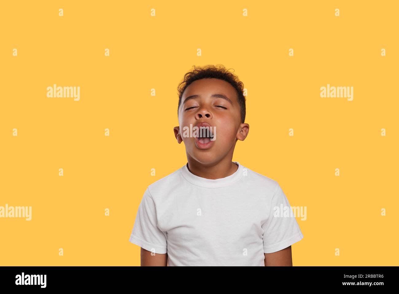 Boy yawning on yellow background. Insomnia problem Stock Photo - Alamy