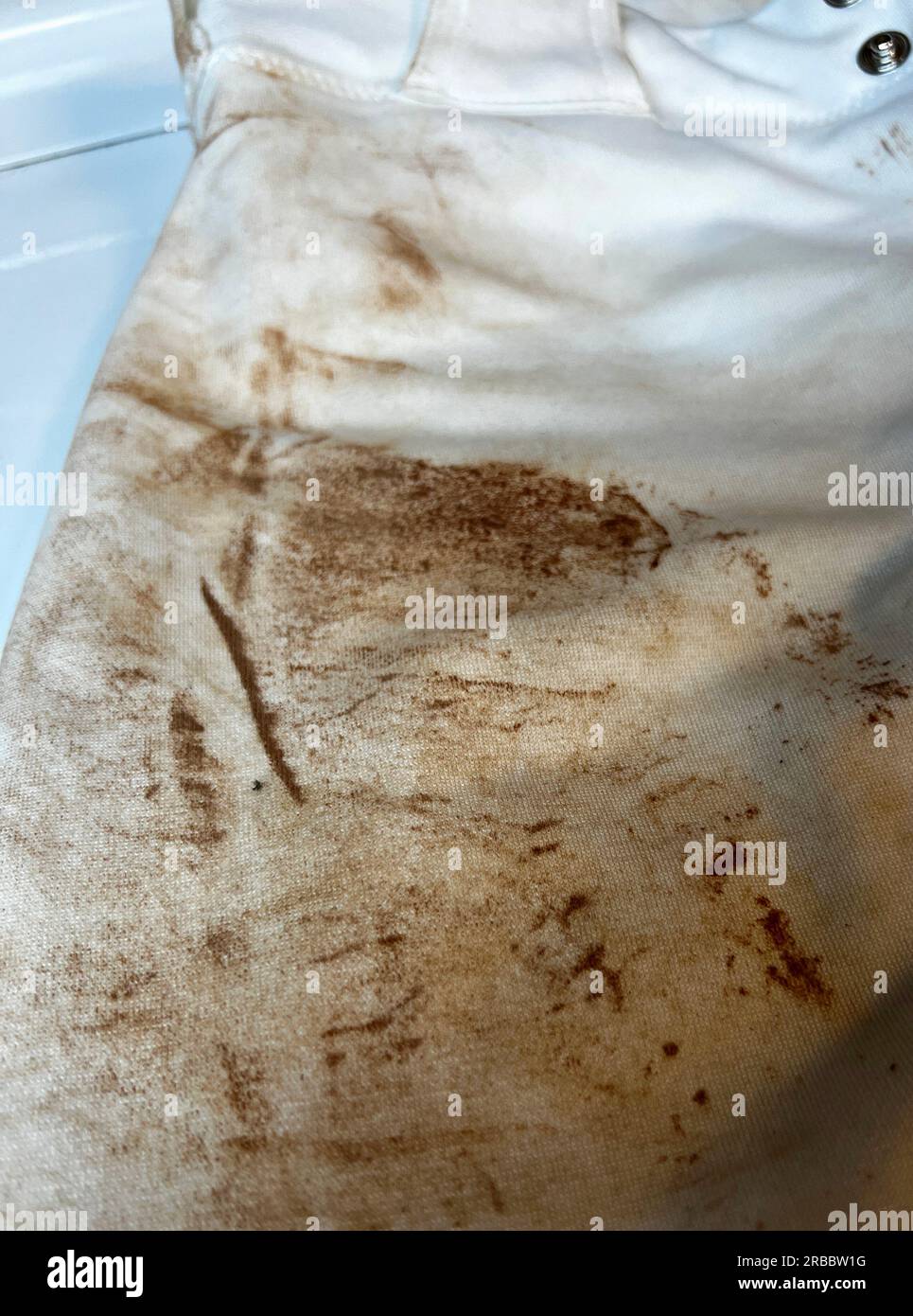Dirt and mud stains on a pair of white athletic pants Stock Photo - Alamy