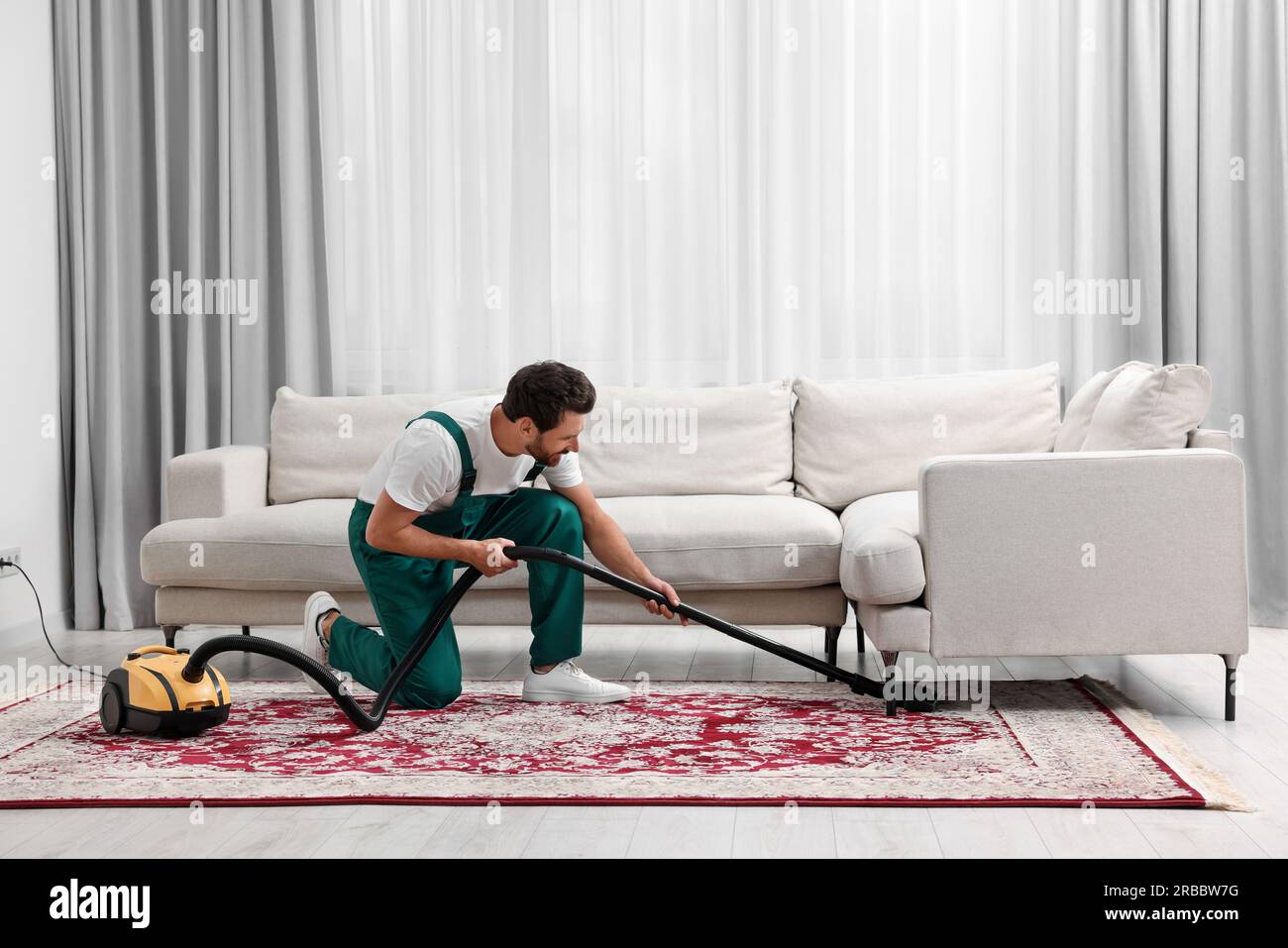 Dry cleaners employee hoovering hi-res stock photography and images - Alamy