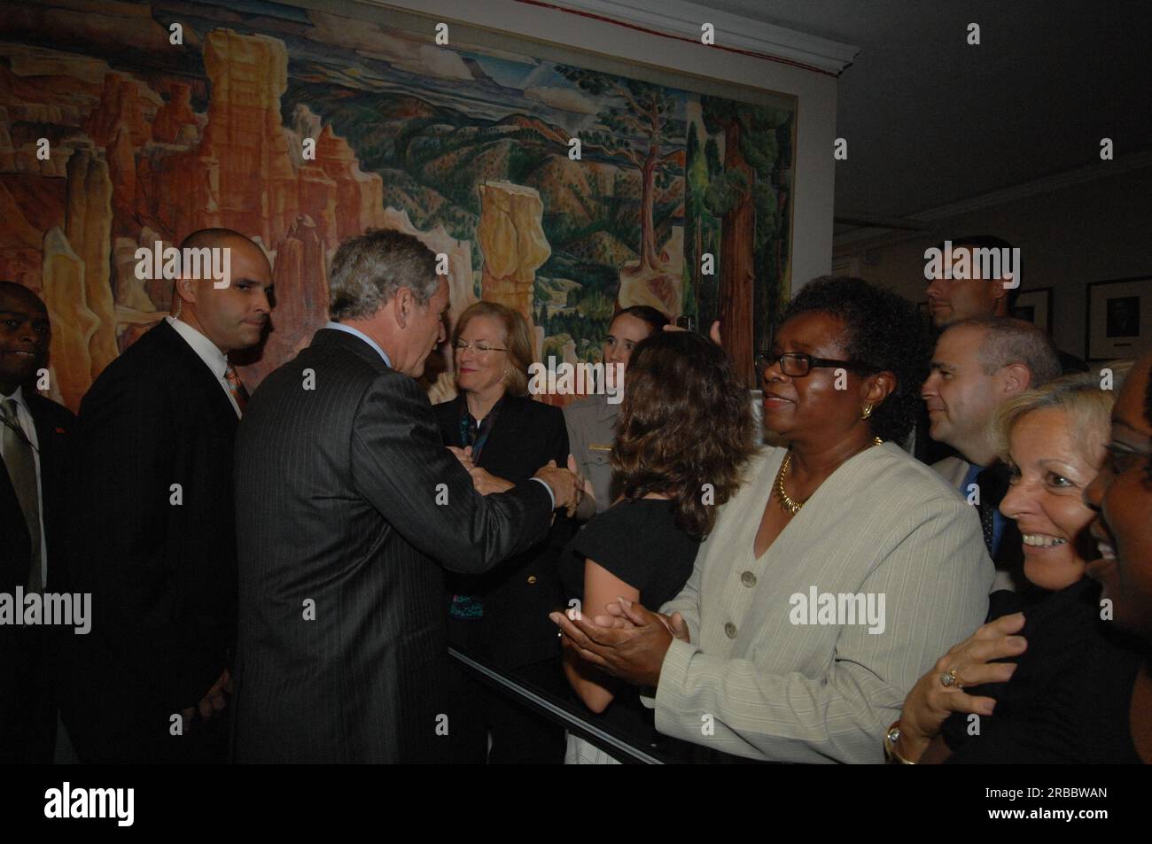 Department staff greeting President George W. Bush, from behind rope ...