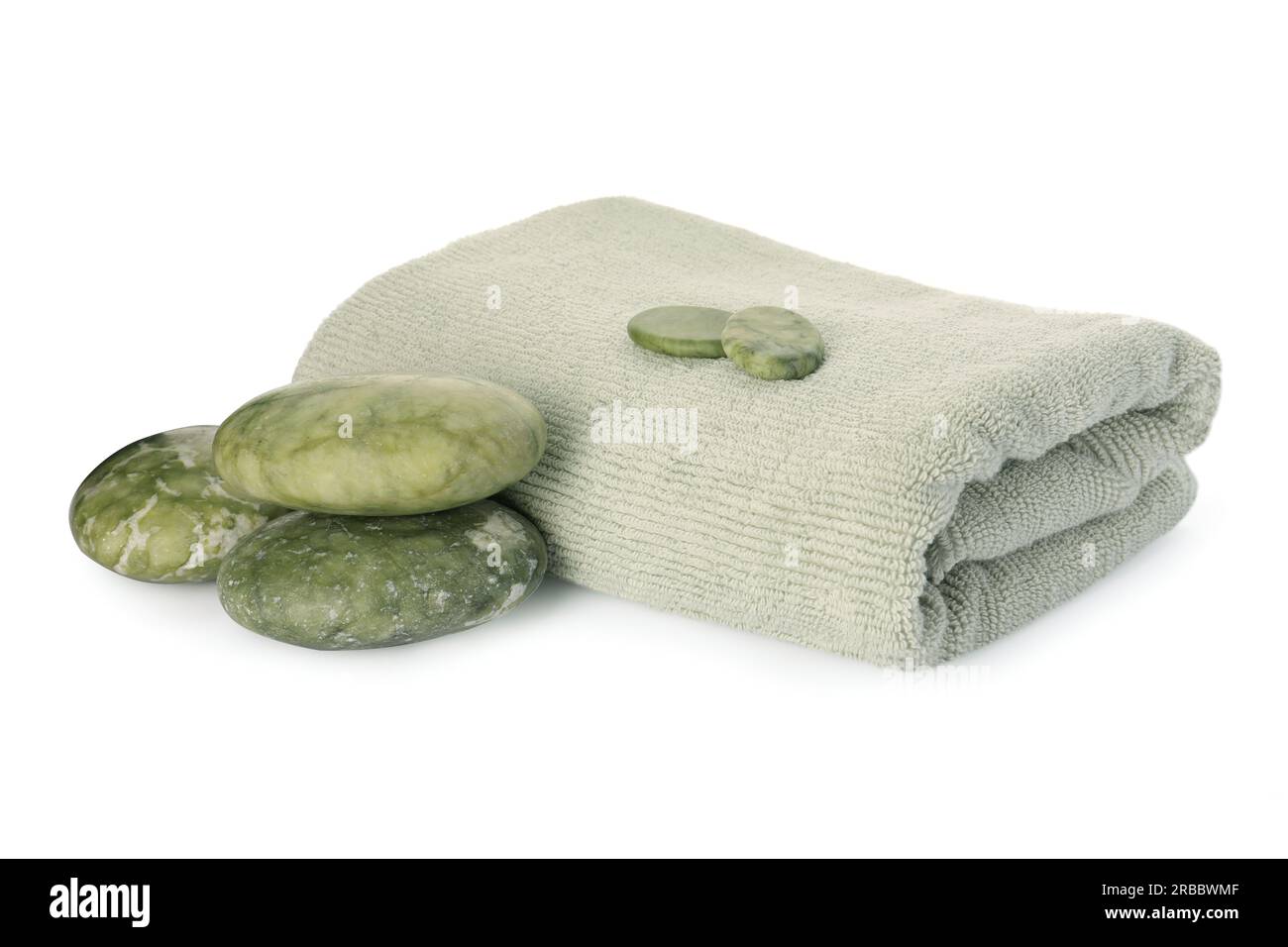 Composition with folded towel and spa stones on white background Stock ...