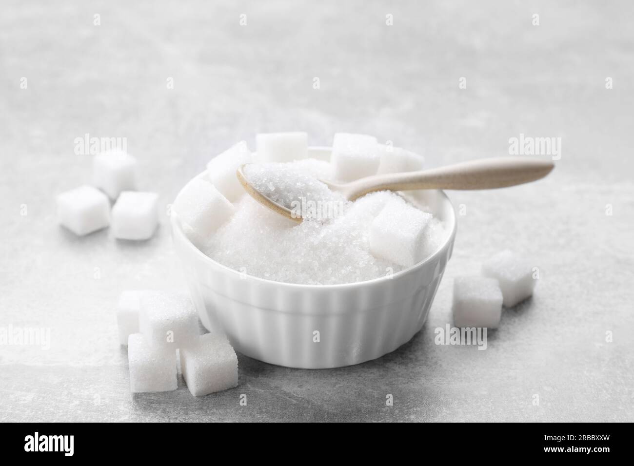 Different types of white sugar on grey table Stock Photo - Alamy