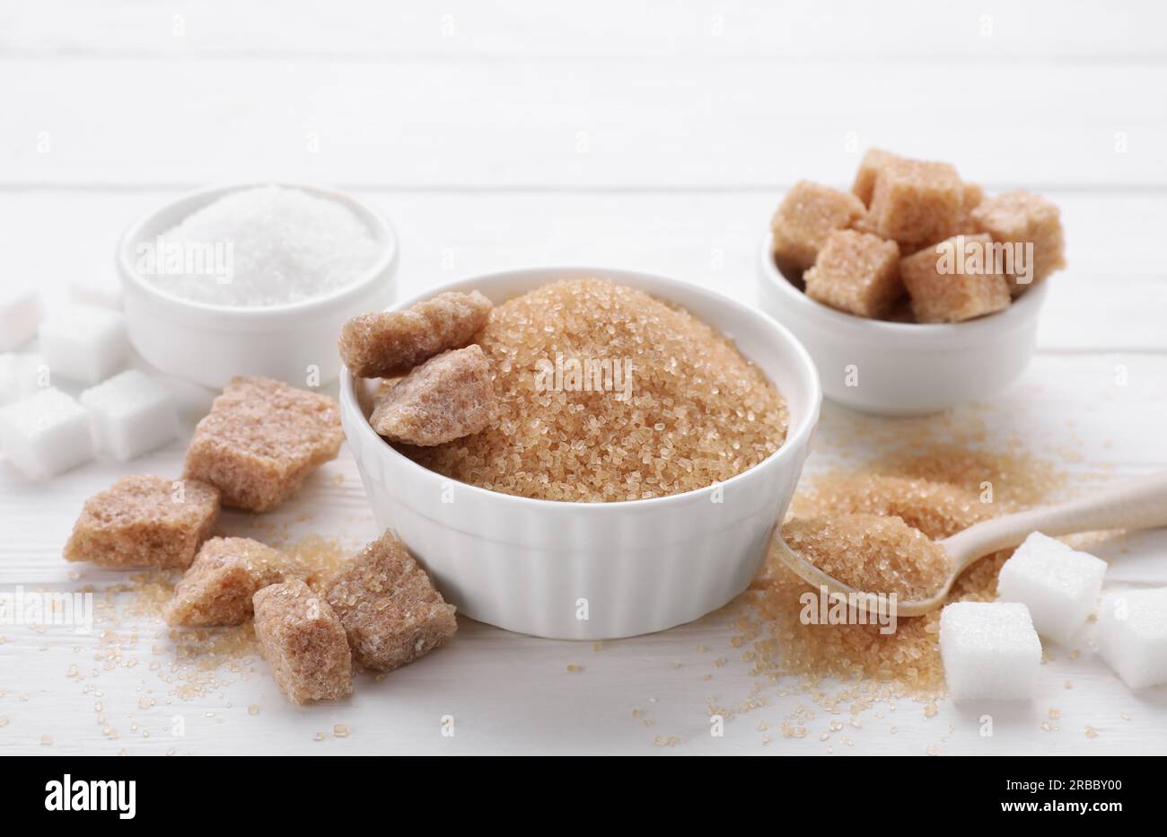 Different types of sugar on white wooden table Stock Photo - Alamy