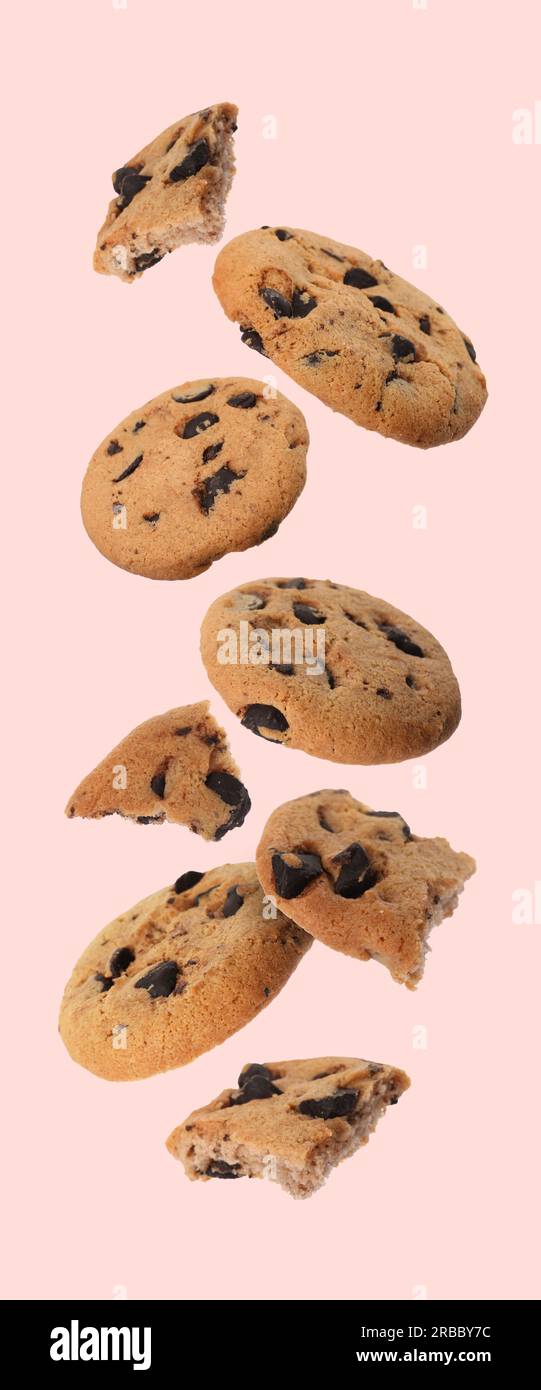 Delicious chocolate chip cookies falling on pink background Stock Photo ...