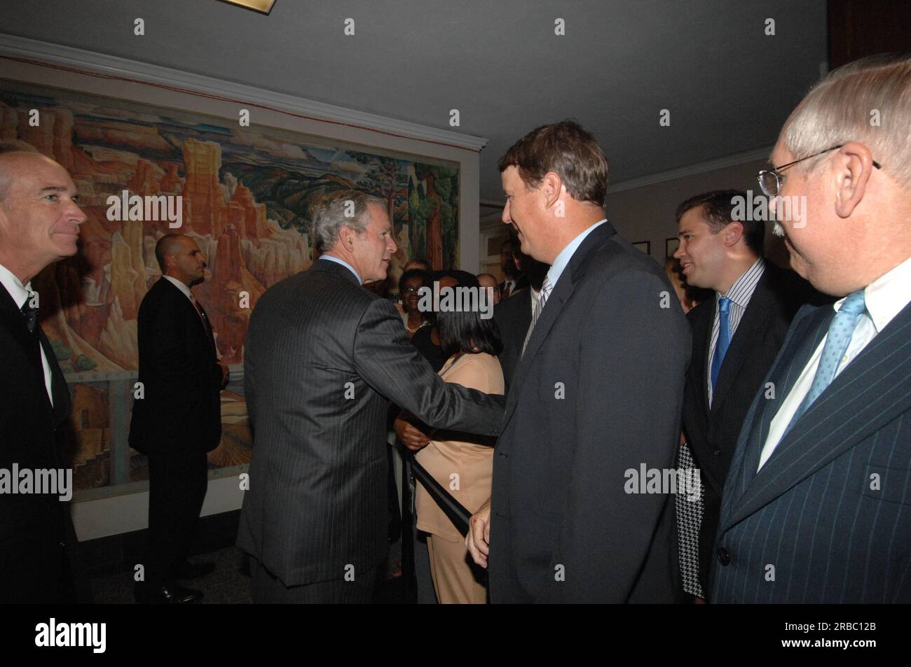 Department staff greeting President George W. Bush, from behind rope ...
