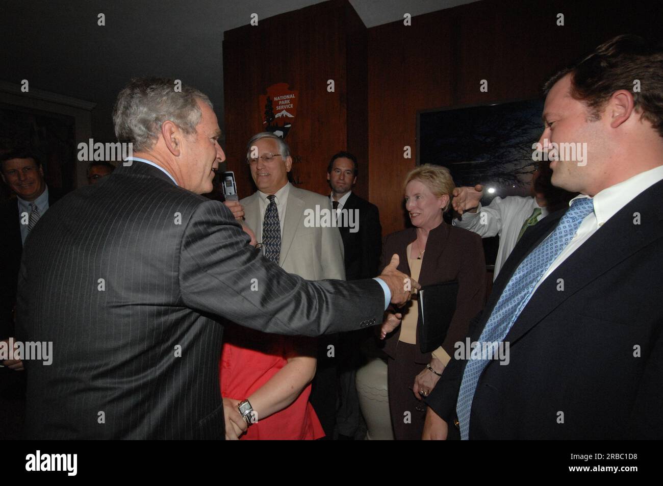 Department staff greeting President George W. Bush, from behind rope ...